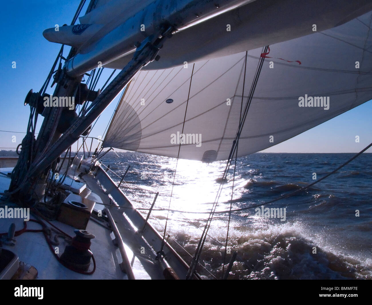 sun setting Scene behind the sails aboard the deck of two mast sail ...