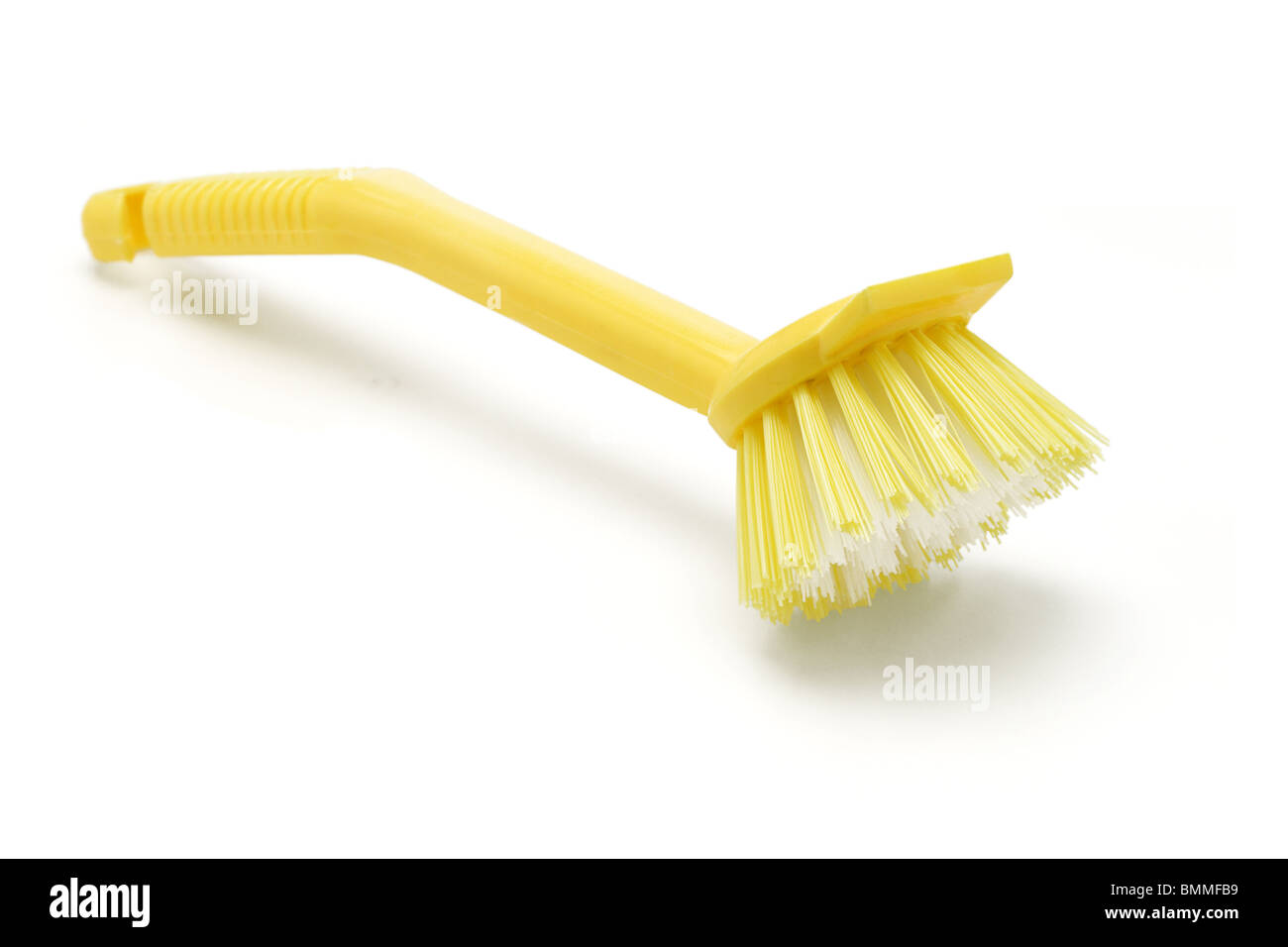 Yellow plastic cleaning brush on white background Stock Photo - Alamy