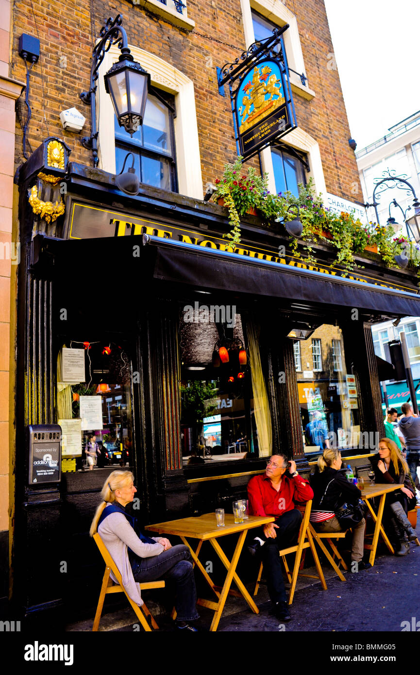 Small Group People Sitting at Tables, Sharing Drinks outside Terrace ...