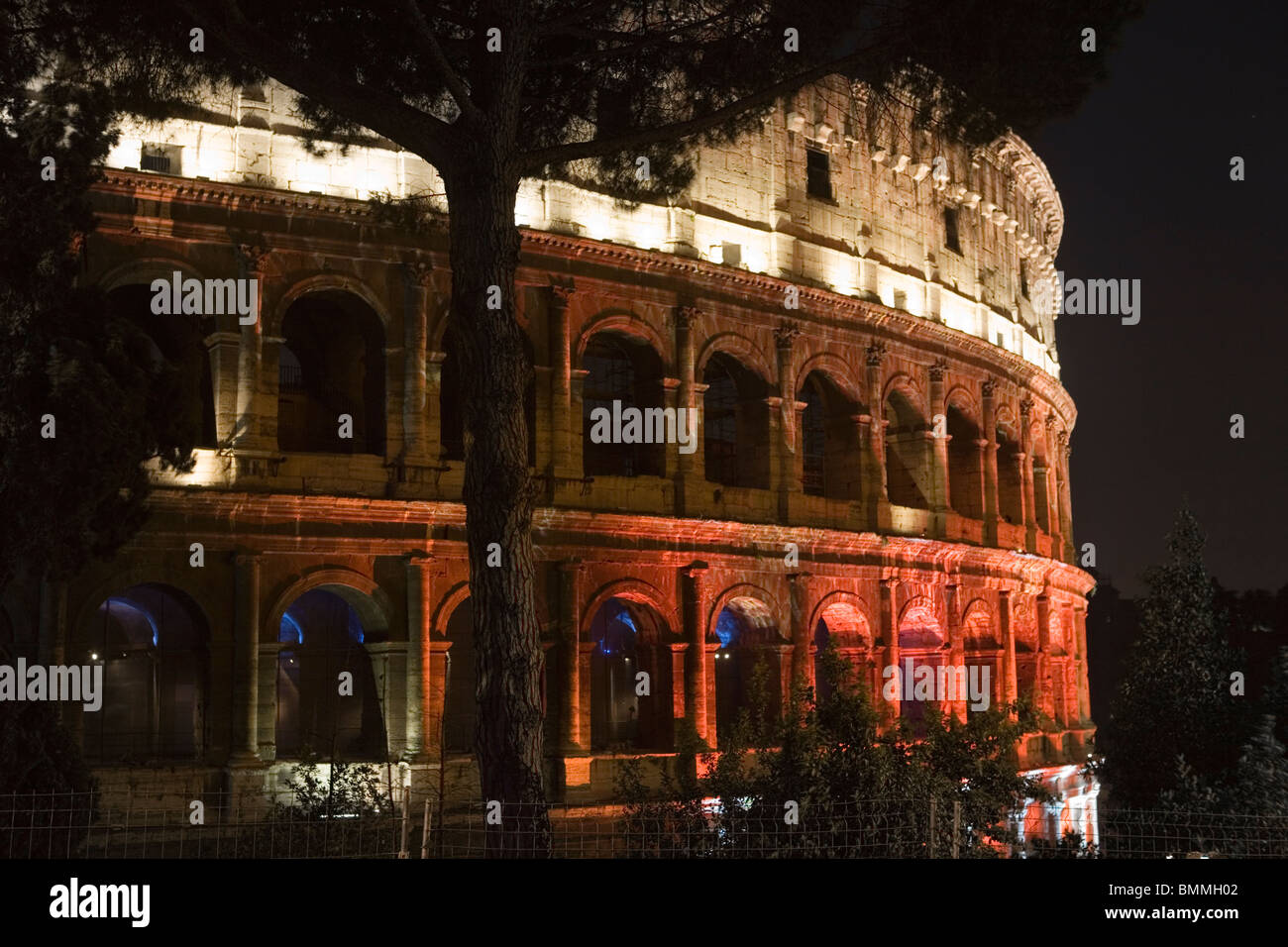 The Colosseum at night, lit in colored lights, Rome, Italy Stock Photo ...