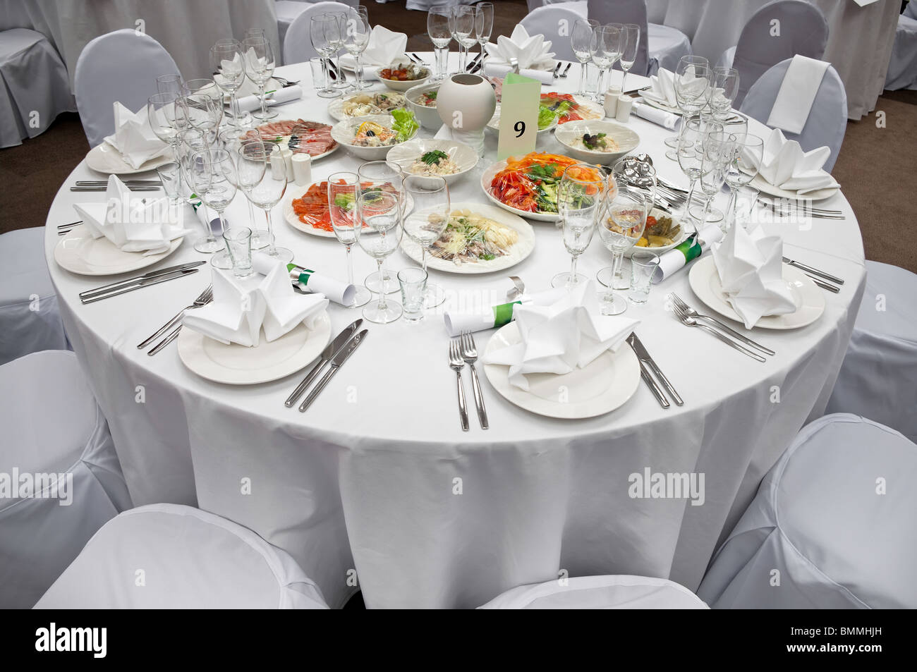 Wedding white reception place ready for guests. Elegant banquet tables ...