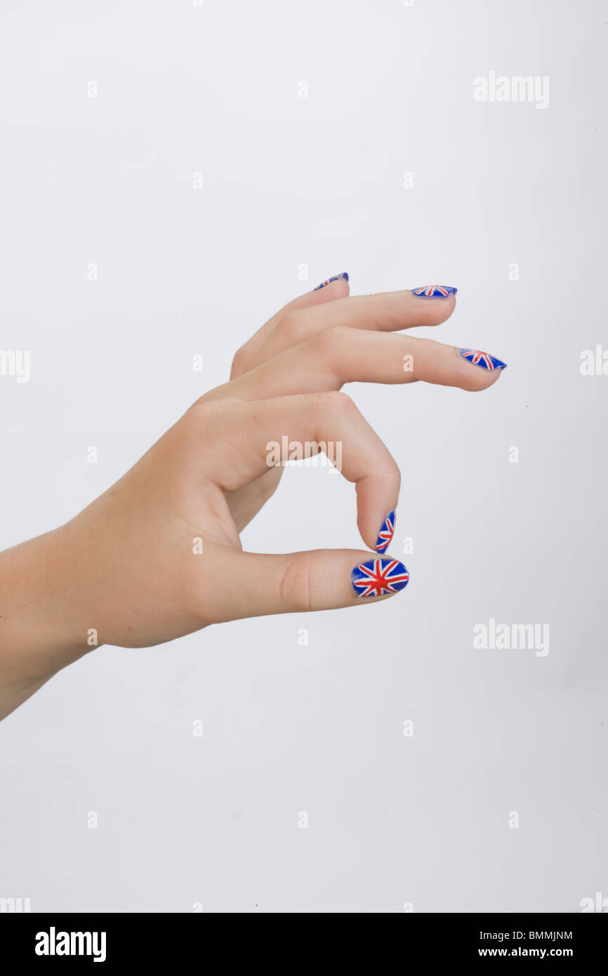 Hand with british flag painted on the fingernails forming an o.k.-sign ...