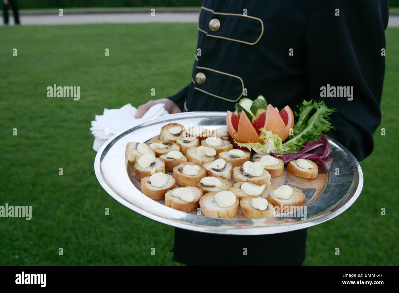 waiter serves fingerfood appetizer Stock Photo - Alamy