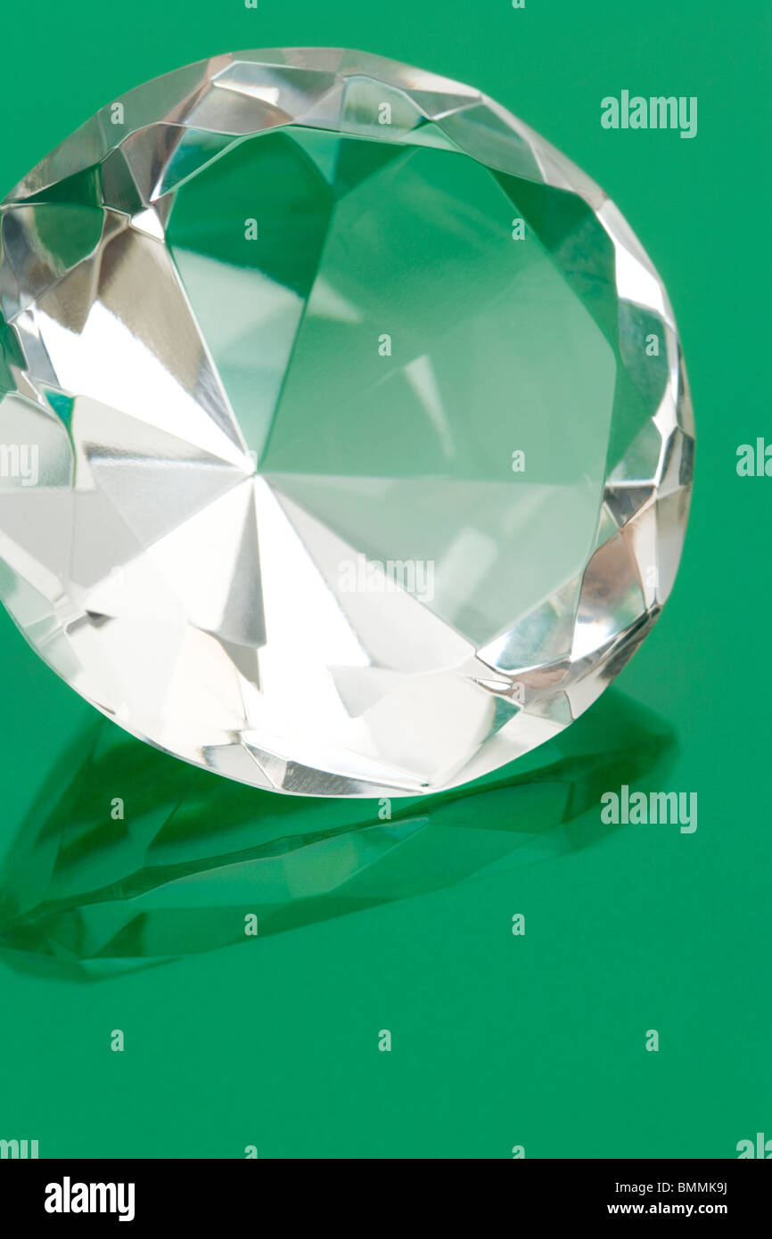 Diamond close up shot with green background Stock Photo - Alamy
