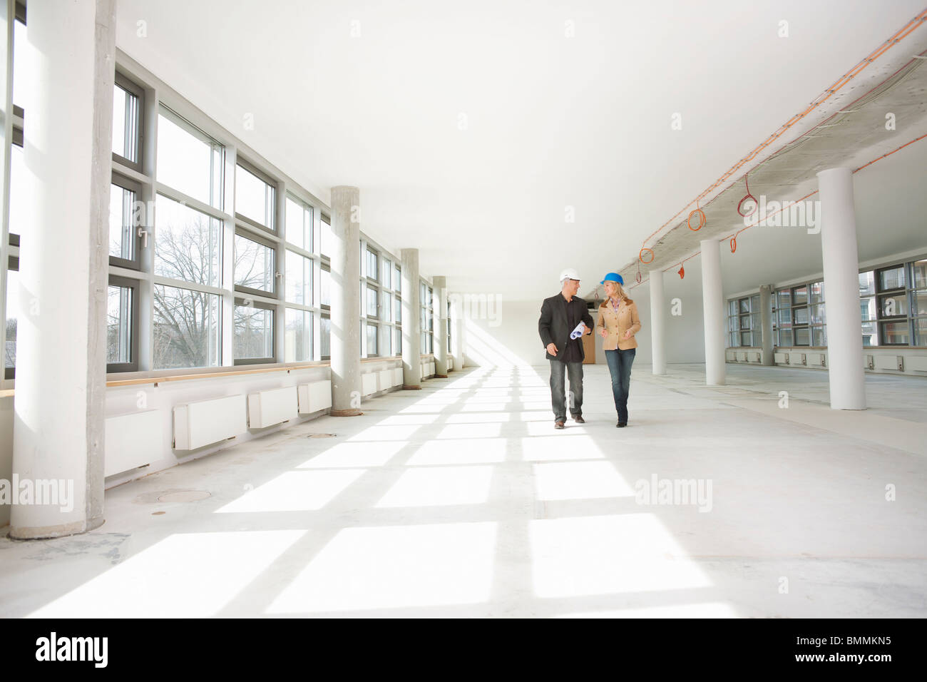 Two architects walking through site Stock Photo - Alamy
