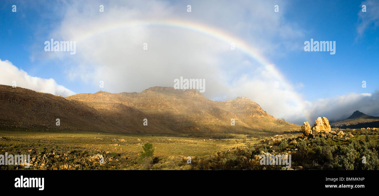 Rainbow over valley with Apollo and Luna Peaks, Cederberg, Western Cape ...