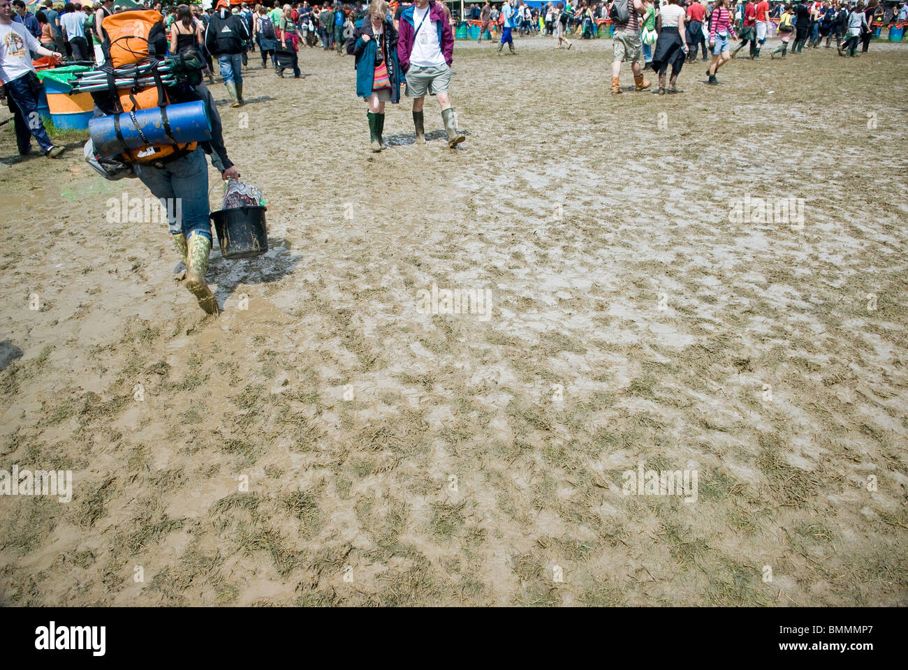 People making their way through thick mud at Glastonbury Festival ...