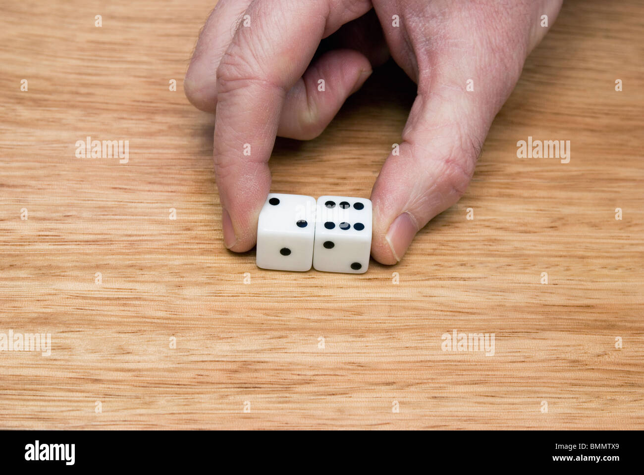 fingers holding pair of dice Stock Photo - Alamy