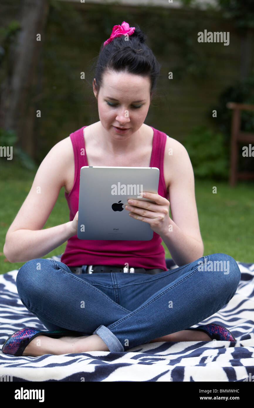 A woman uses a Ipad in the garden Stock Photo - Alamy