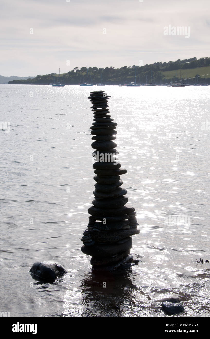 a rock/stone pillar made out of beach pebbles Stock Photo - Alamy