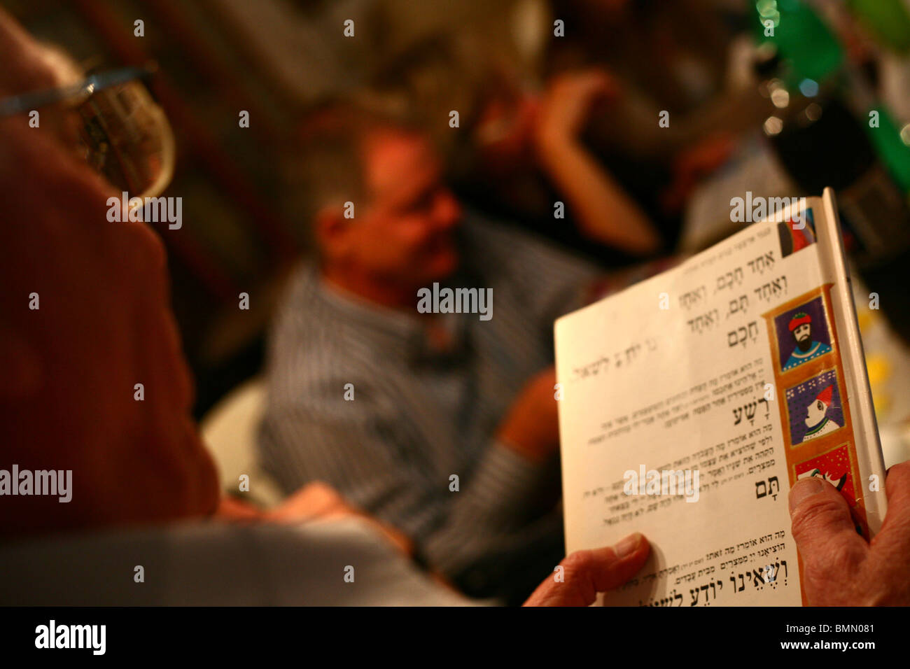 family sitting around a table set for a Jewish Festive meal on Passover ...