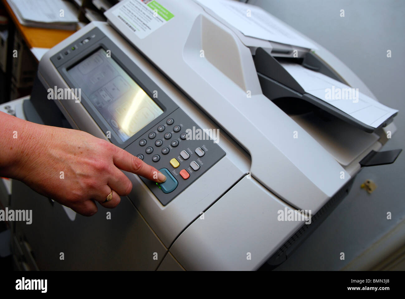 Office worker using copying machine, Wirral, UK Stock Photo - Alamy