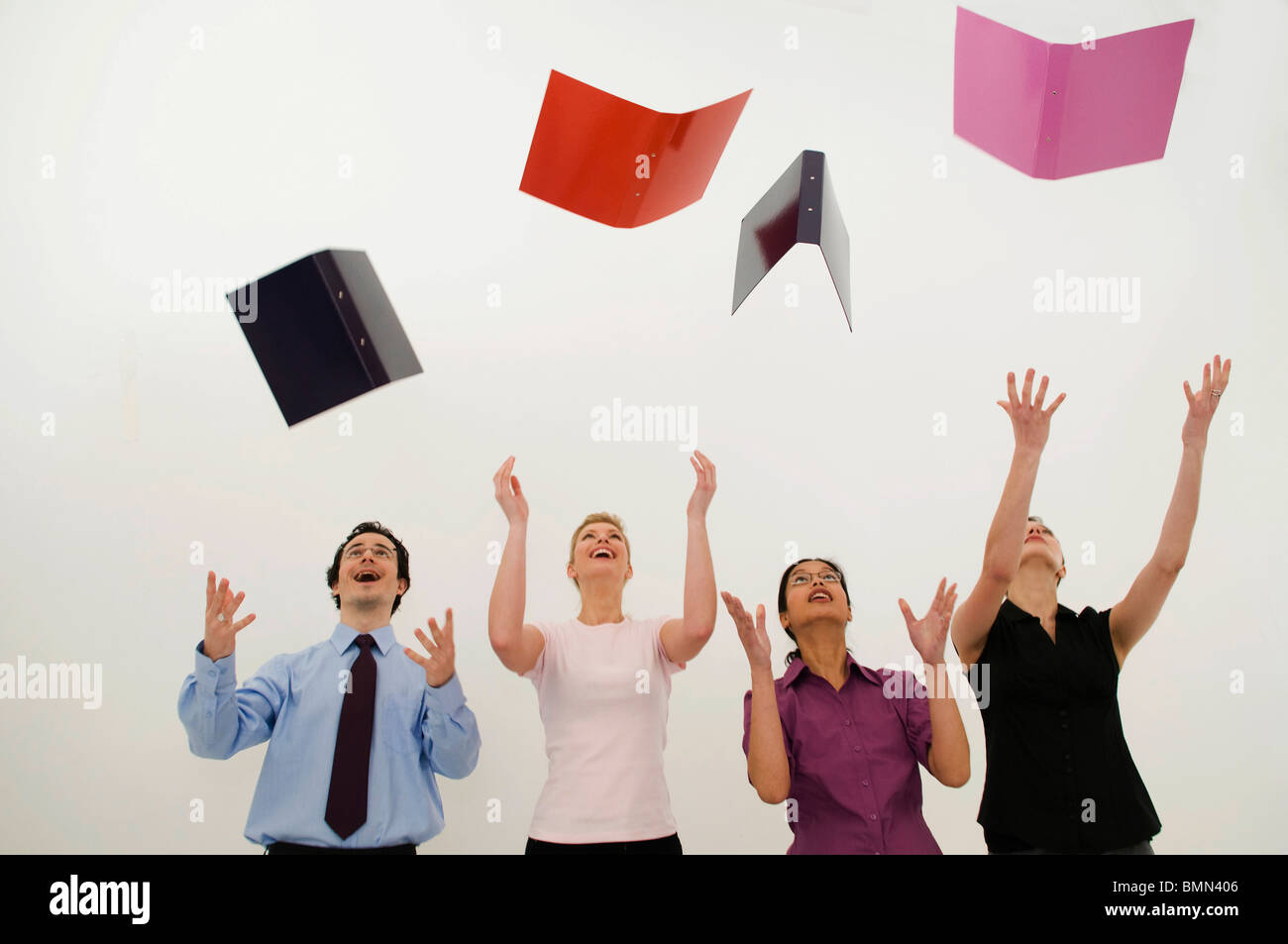 Jubilant business people throw folders Stock Photo - Alamy