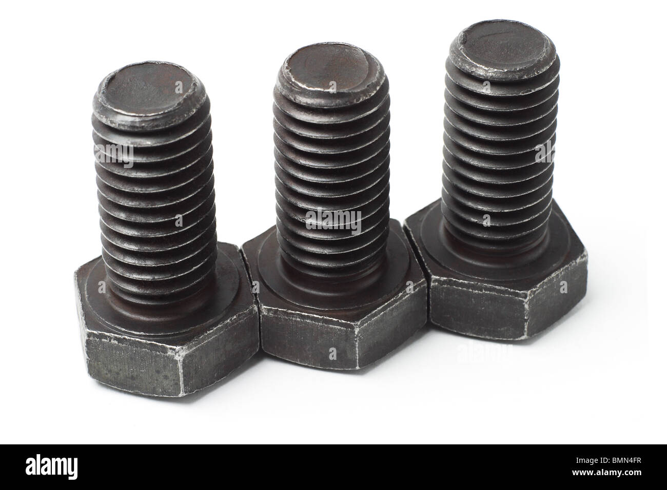 Three large used bolts in a row on white background Stock Photo - Alamy