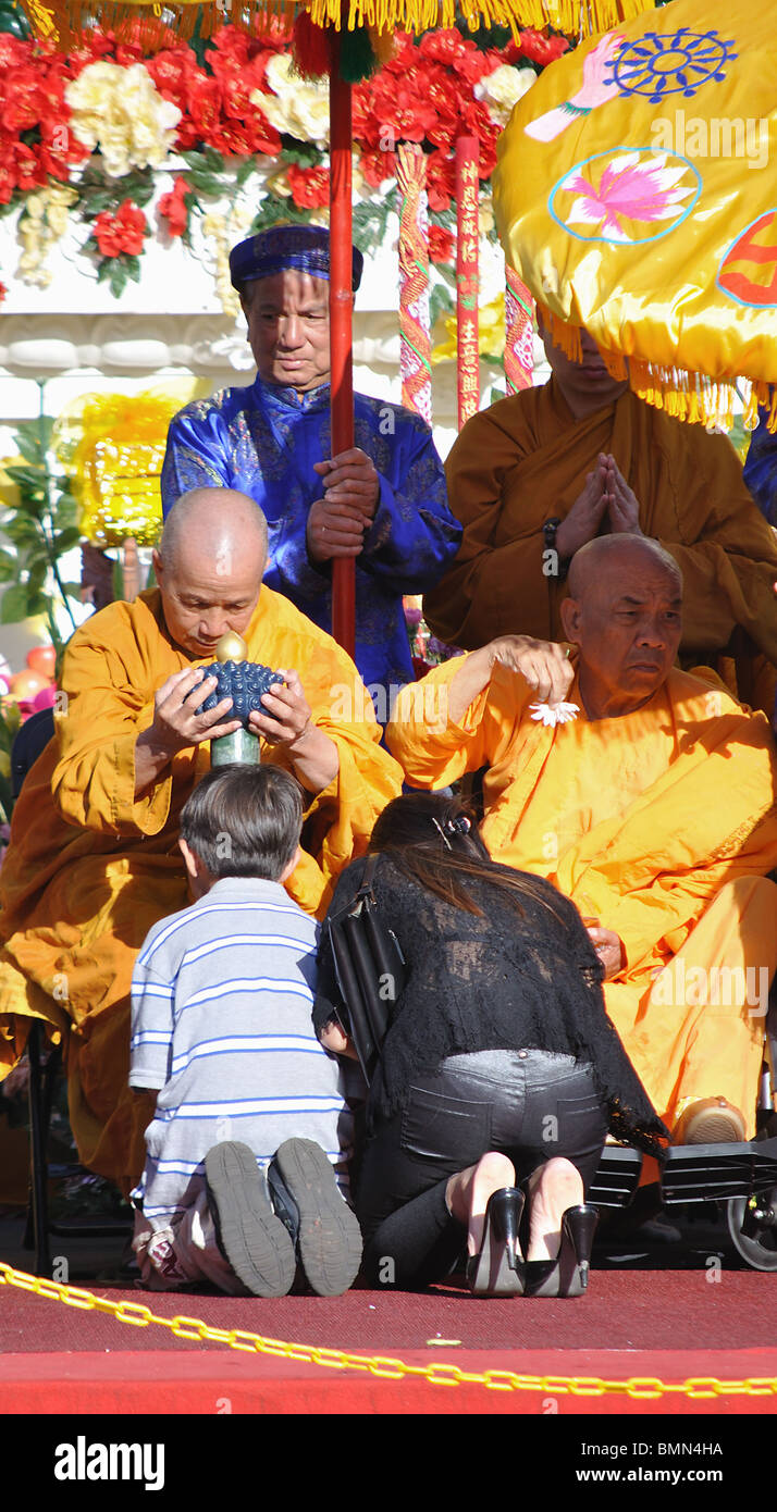 Buddhist monk blessing child with the top knot of the jade Buddha Stock ...