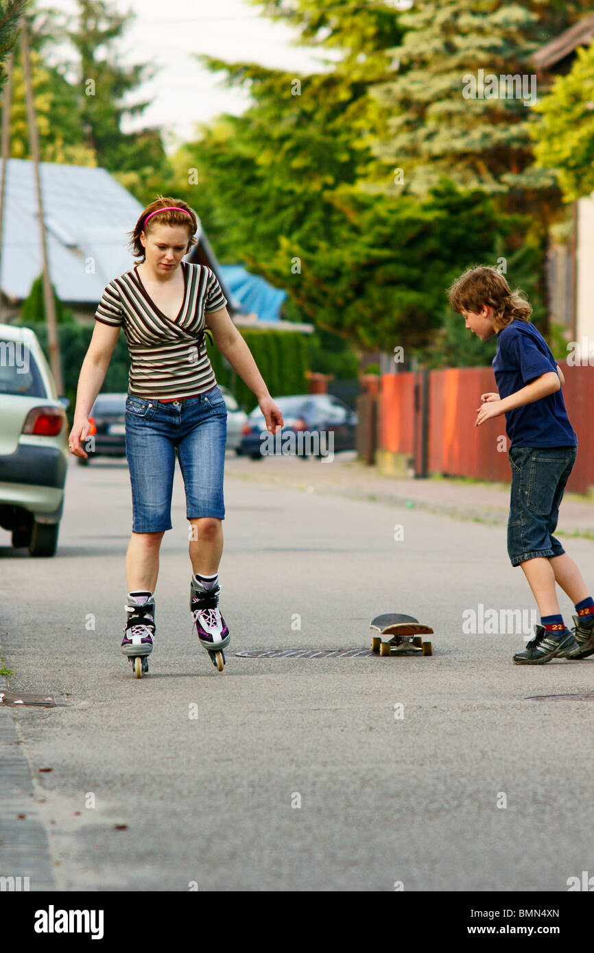 Mum skating with son Stock Photo - Alamy