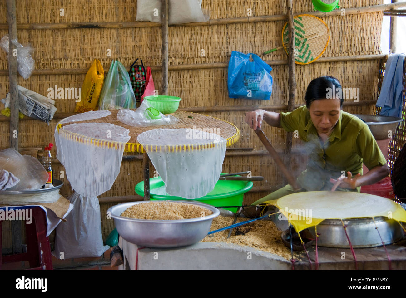 A Vietnamese woman making rice paper Stock Photo - Alamy