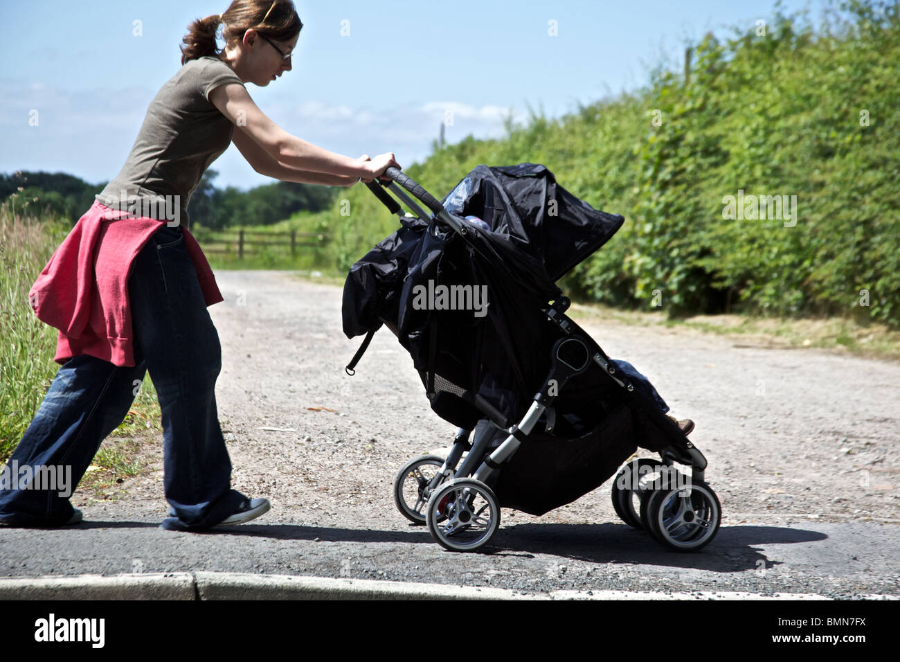 young girl pushing a pram Stock Photo - Alamy