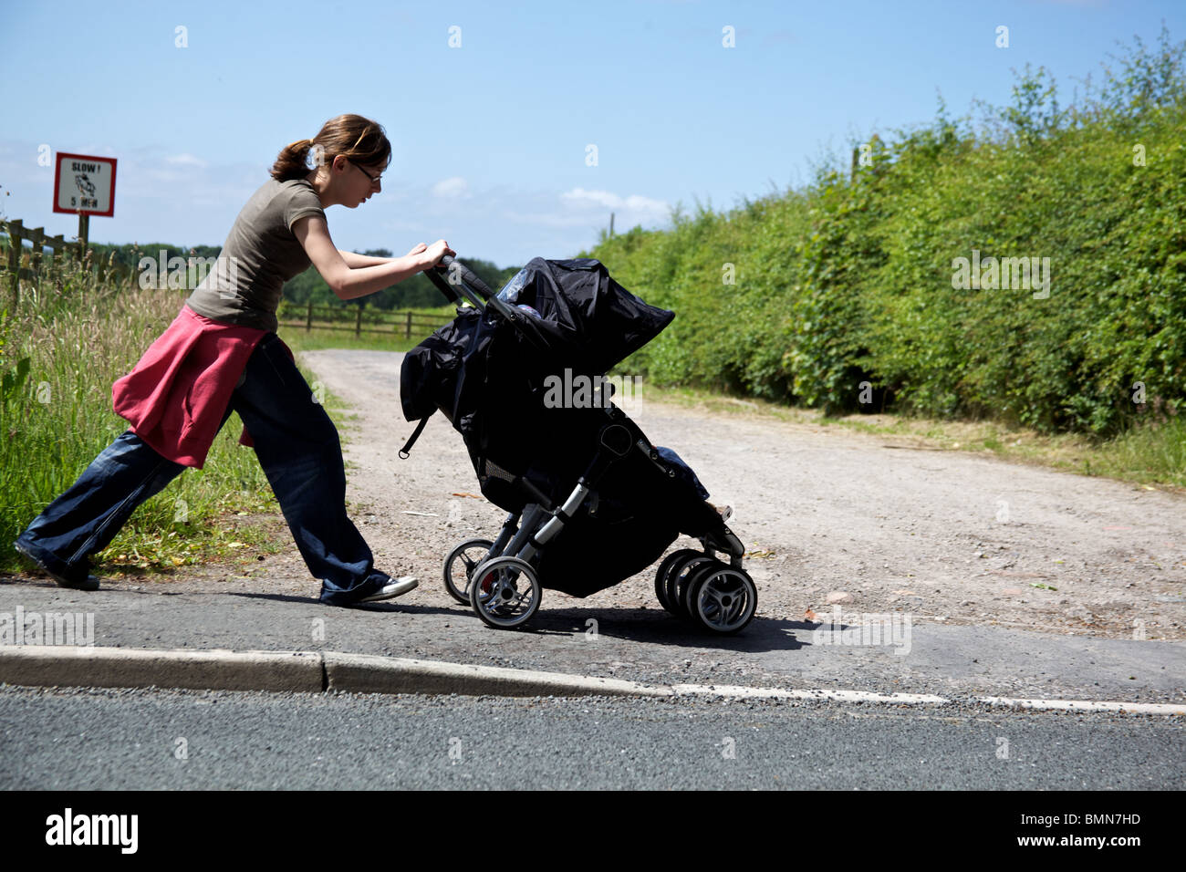 young girl pushing a pram Stock Photo - Alamy