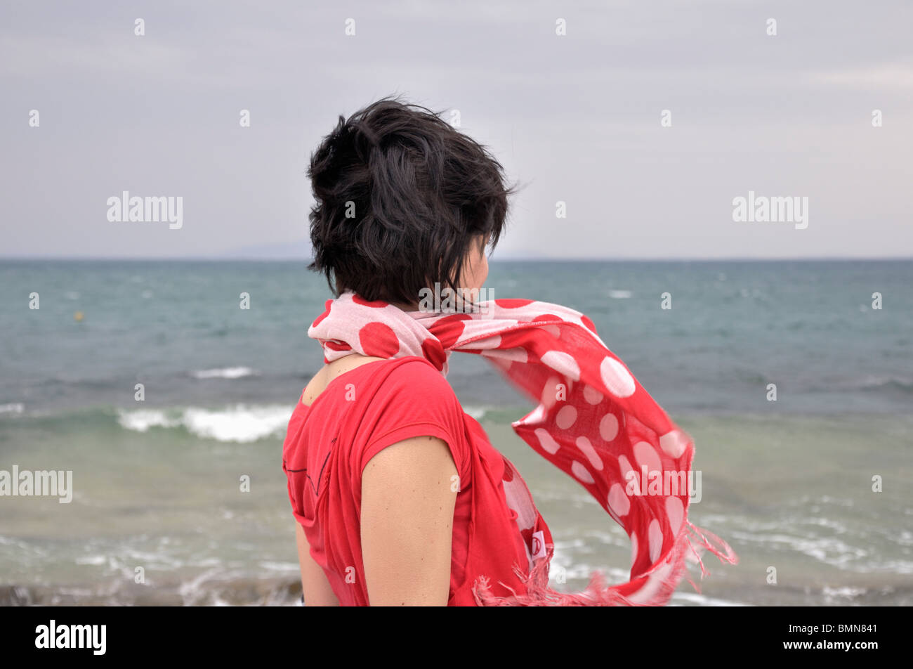 Woman with flowing red scarf Stock Photo - Alamy