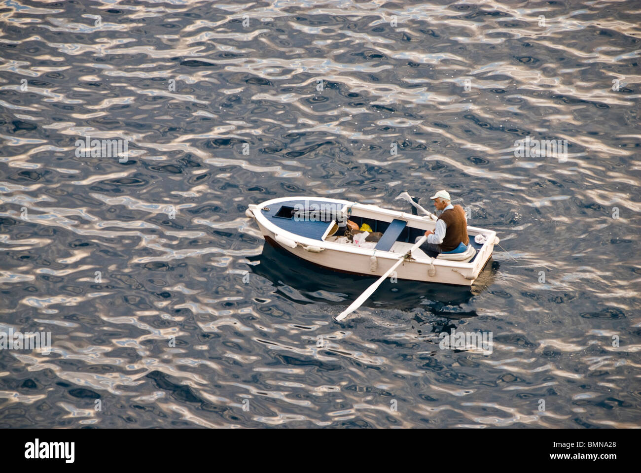 Old man rowing a small boat in the coast of Dubrovnik. Croatia, Europe ...