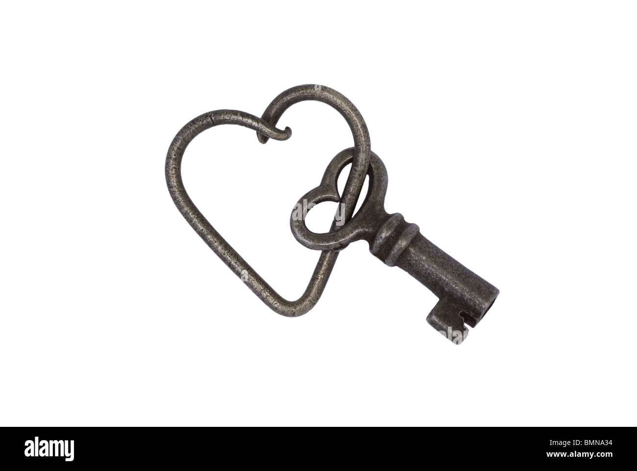 Skeleton key & heart ring locked together. Old metal heart key chain ...