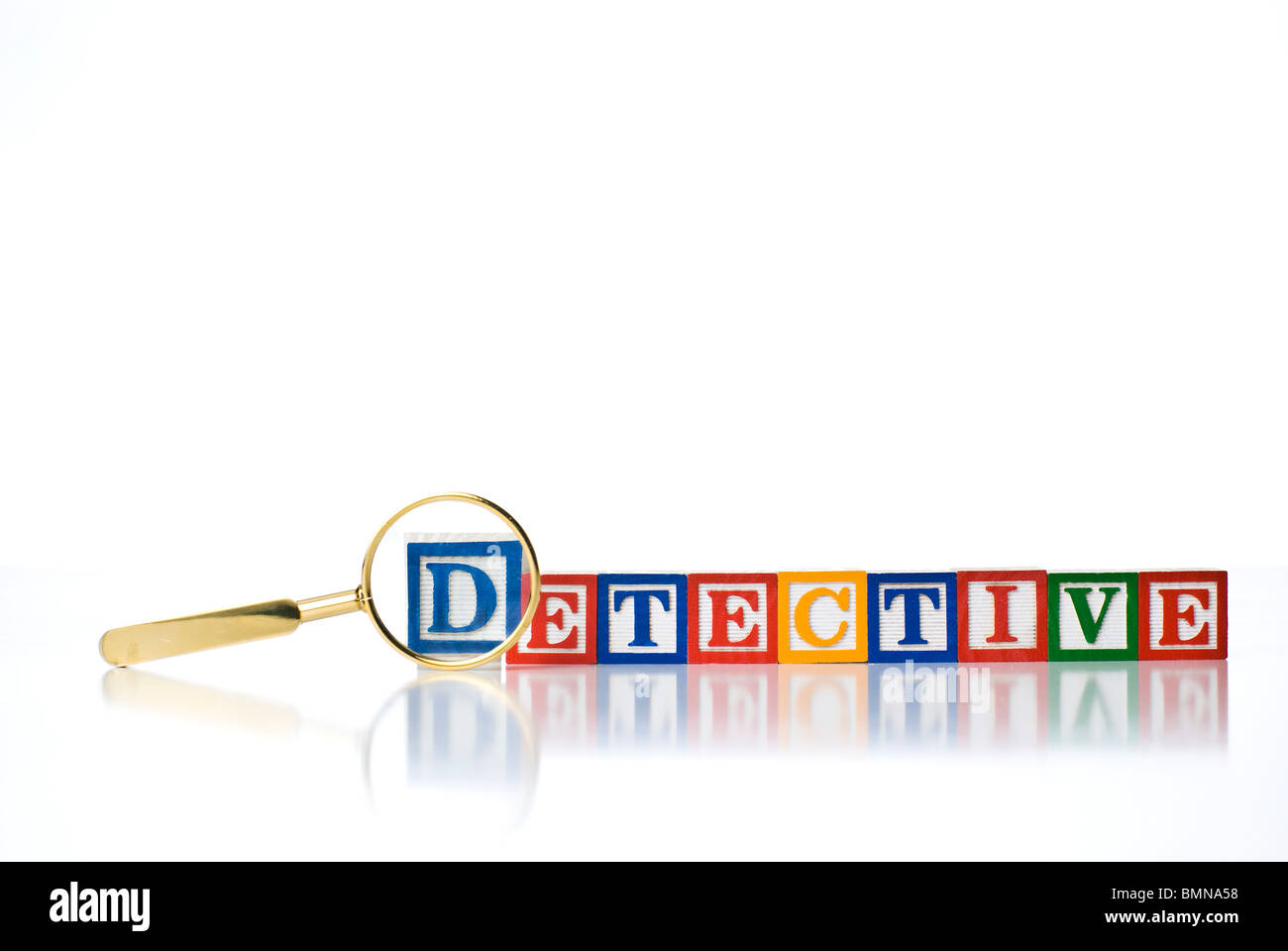 Colorful children's blocks spelling DETECTIVE with a magnifying glass ...