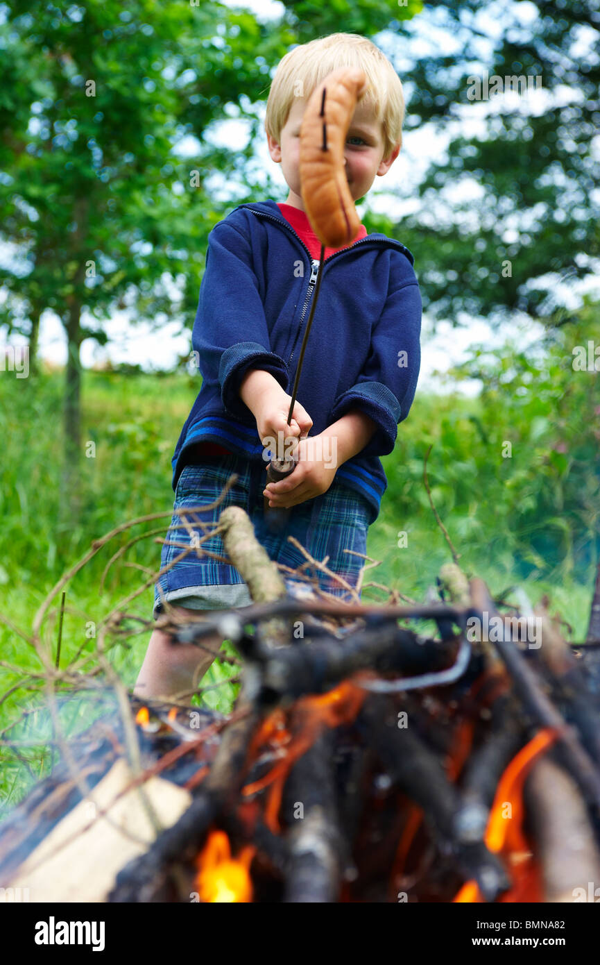 Child burning food on barbeque hi-res stock photography and images - Alamy