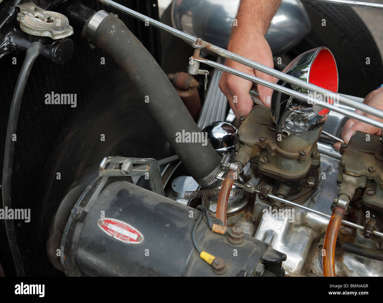 Man tinkering with a car engine Stock Photo - Alamy