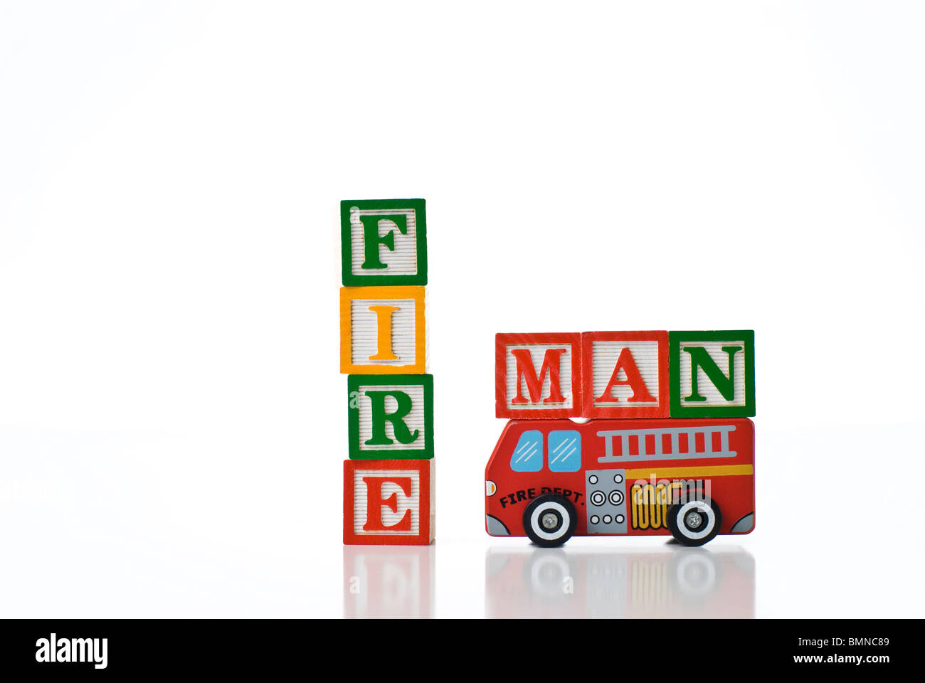 Colorful children's blocks spelling FIREMAN with a toy fire truck Stock ...