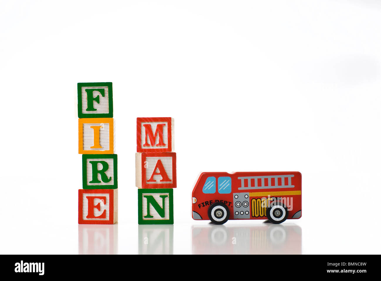 Colorful children's blocks spelling FIREMAN with a toy fire truck Stock ...