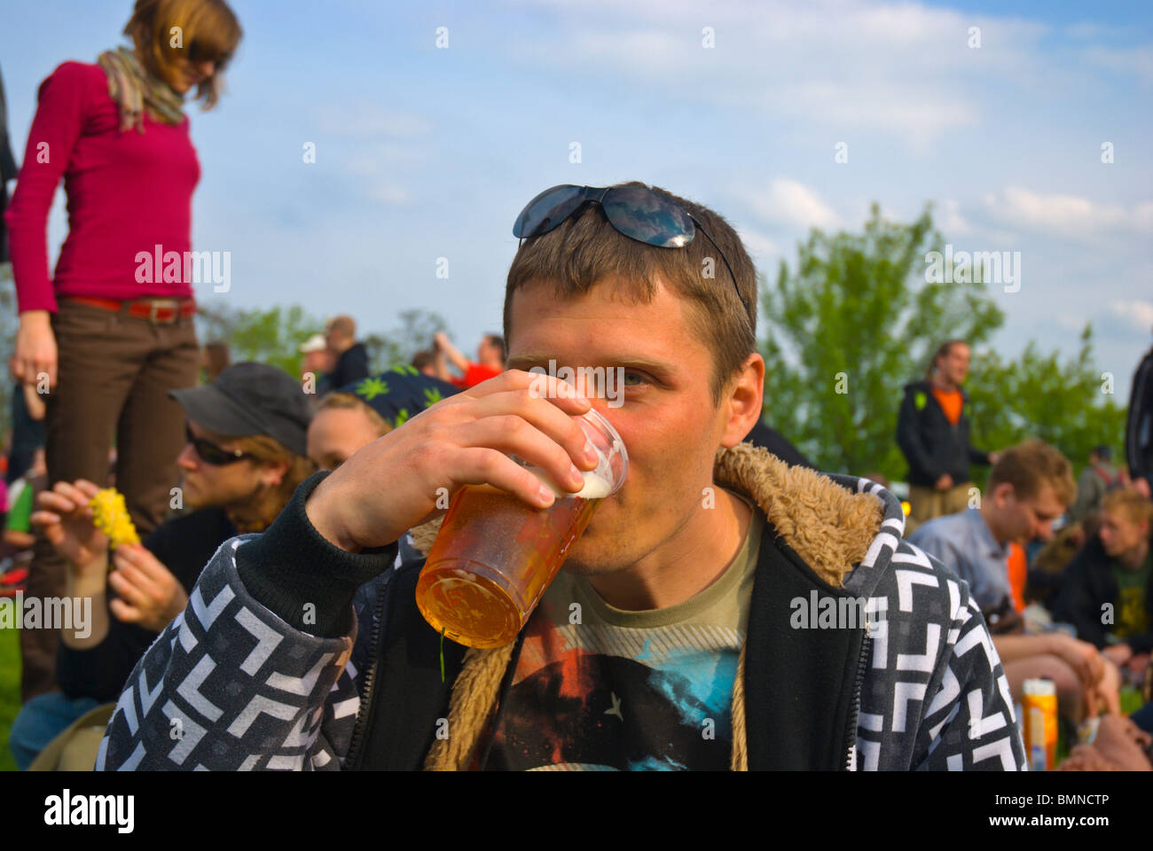 Russian man in his 30s drinking beer out of plastic cup Zizkov district ...