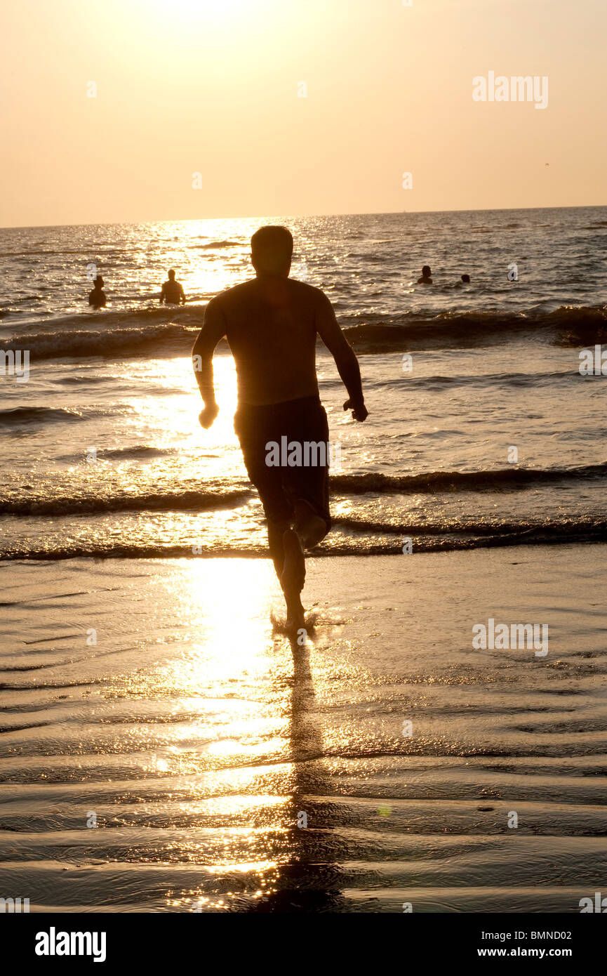 Puerto Vallarta, Mexico; Man Running Into The Water Stock Photo - Alamy