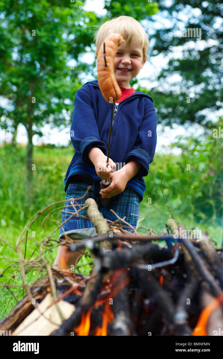 Child burning food on barbeque hi-res stock photography and images - Alamy