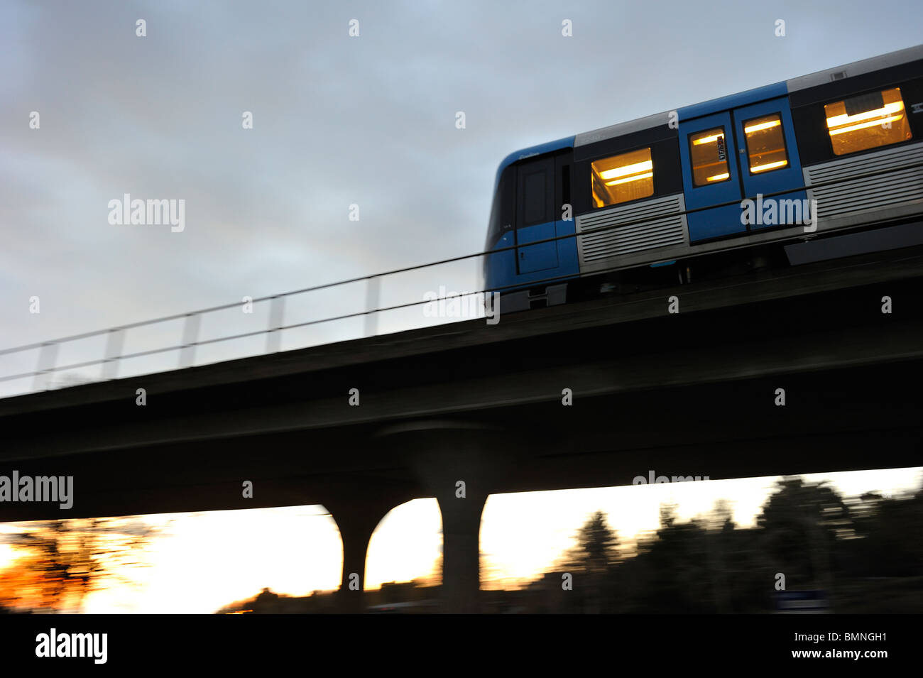 Subway train on a bridge in sunset Stock Photo - Alamy