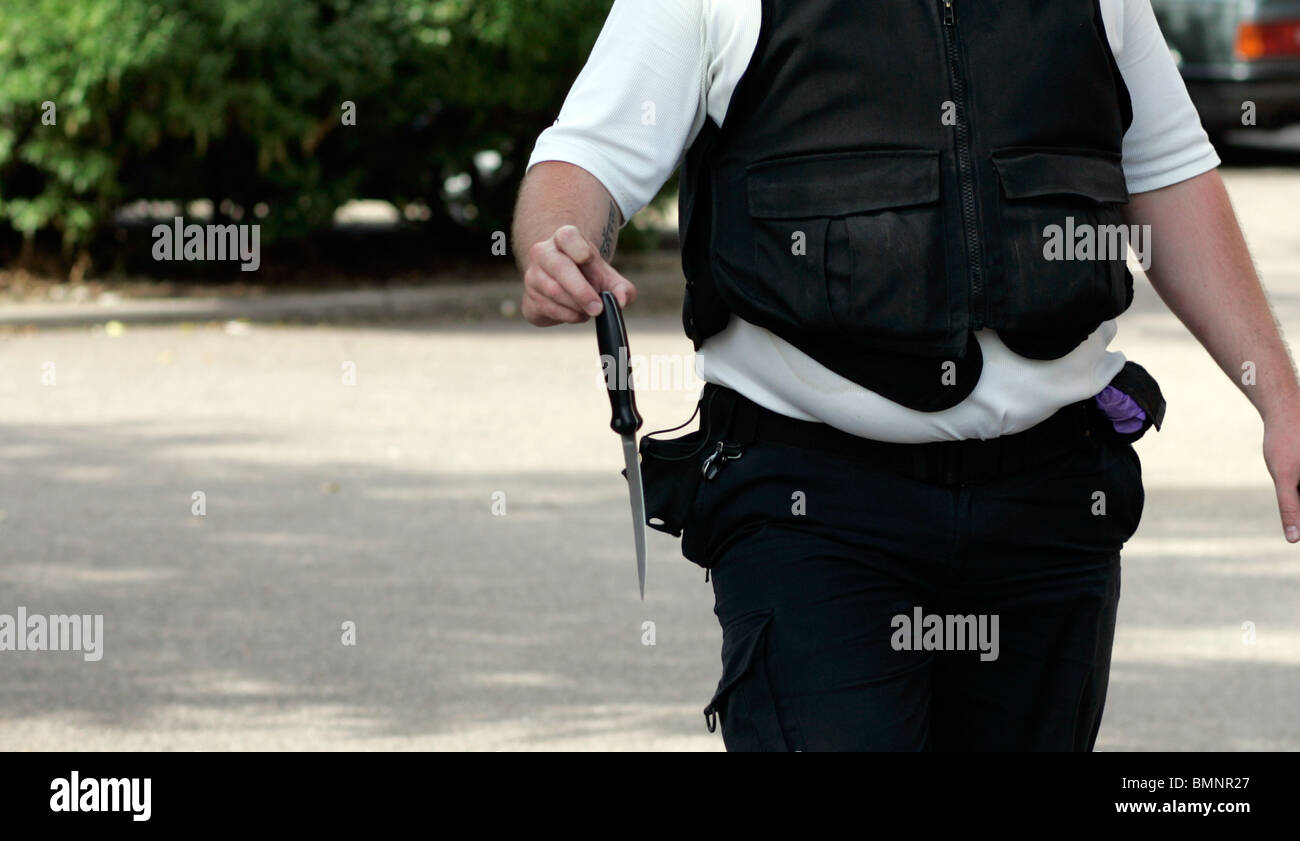 police recover a knife during a stop and search Stock Photo - Alamy