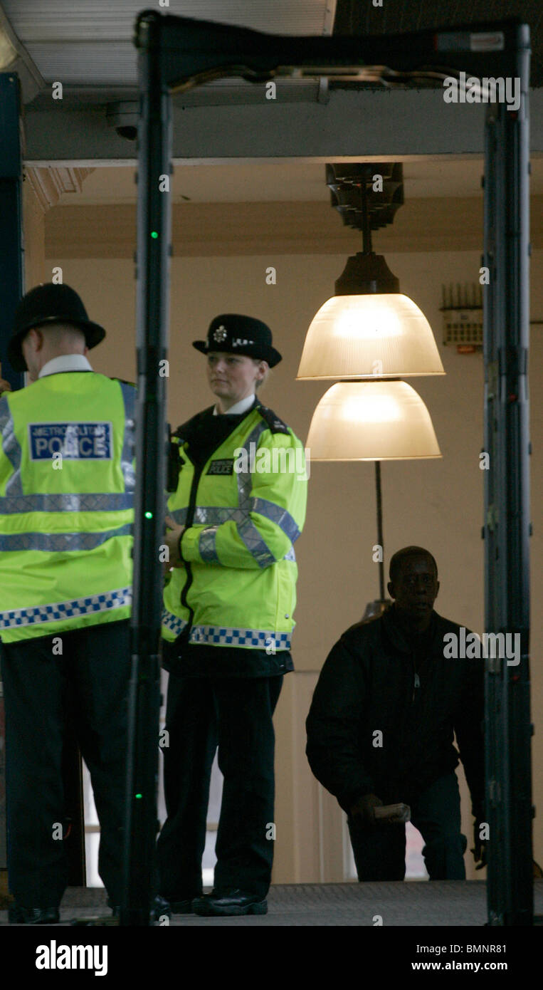 police perform a stop and search with a knife arch in a railway station ...