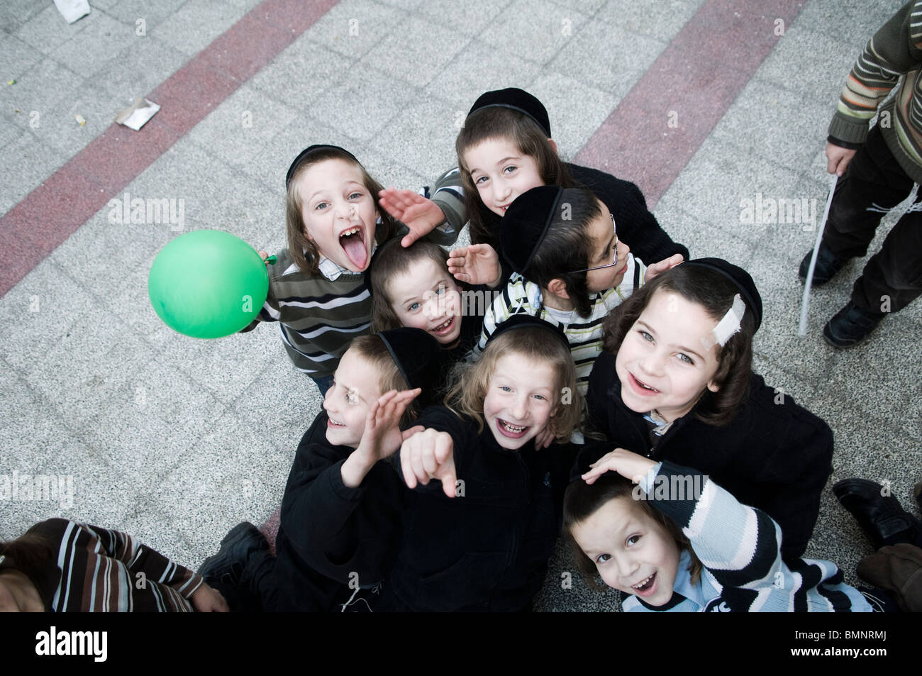cheerful & happy. Orthodox Jewish boys having fun in the courtyard of ...