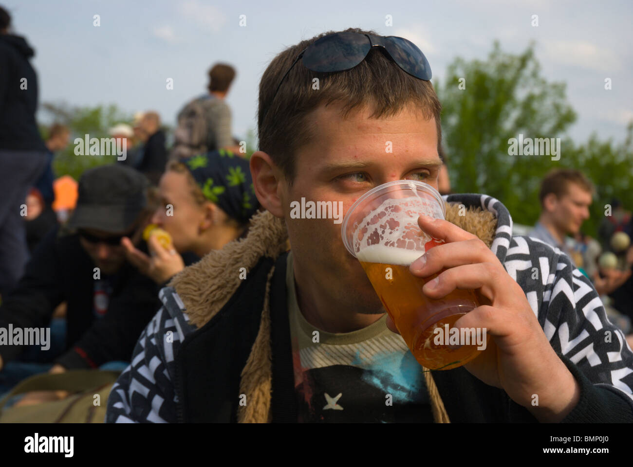 Russian man in his 30s drinking beer out of plastic cup Zizkov district ...