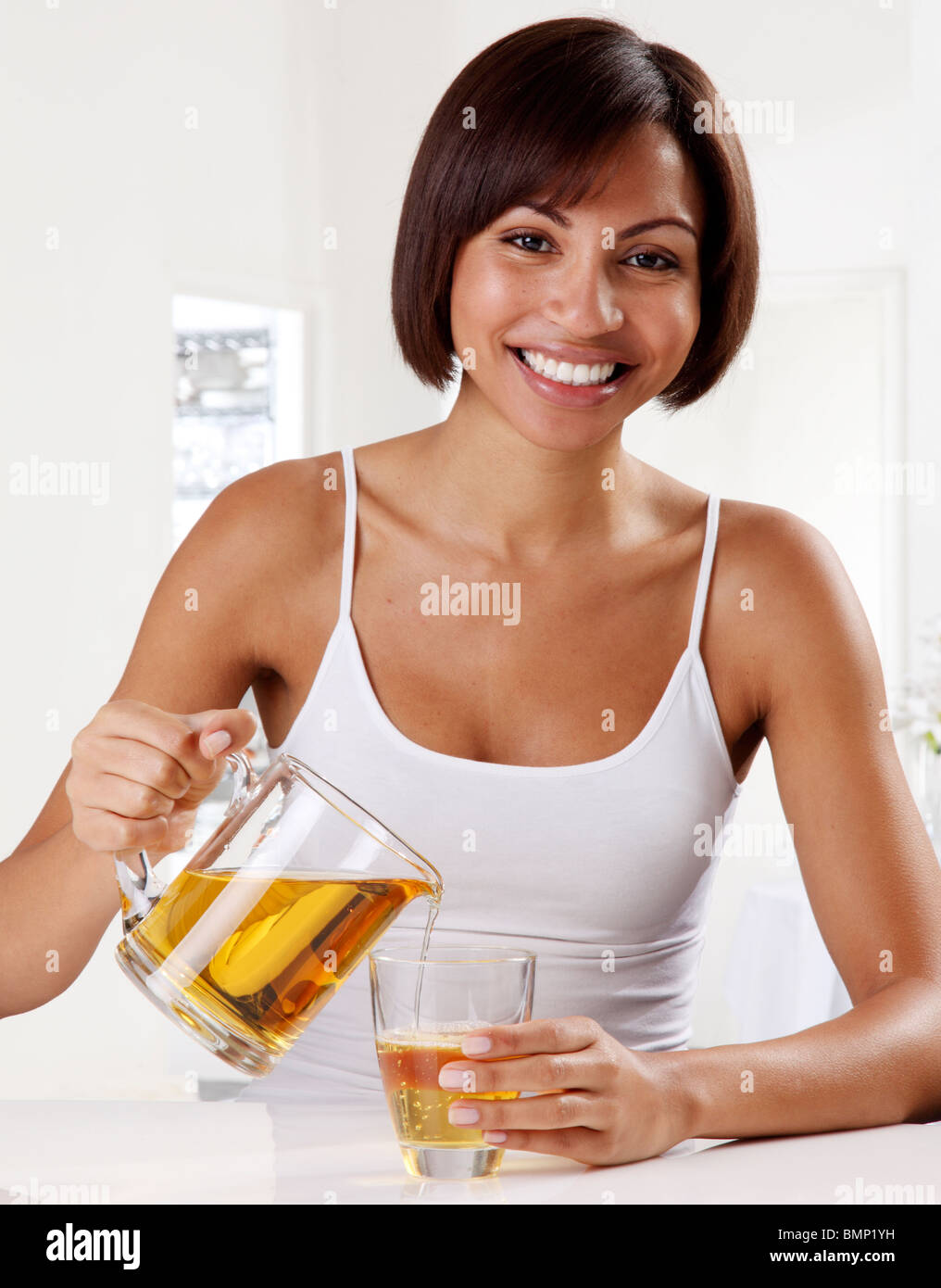 WOMAN POURING APPLE JUICE Stock Photo - Alamy