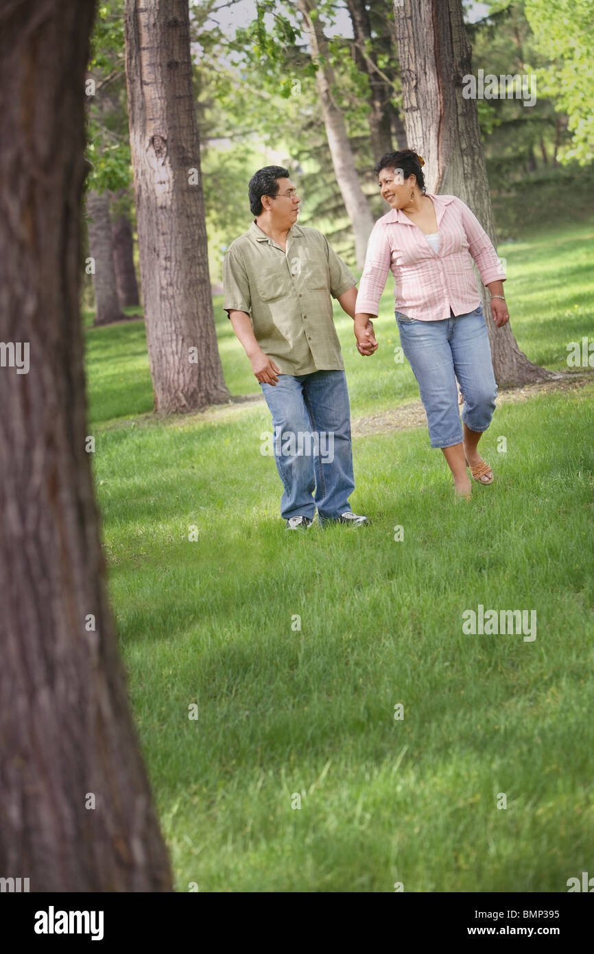 Couple enjoying walk through grass hi-res stock photography and images ...