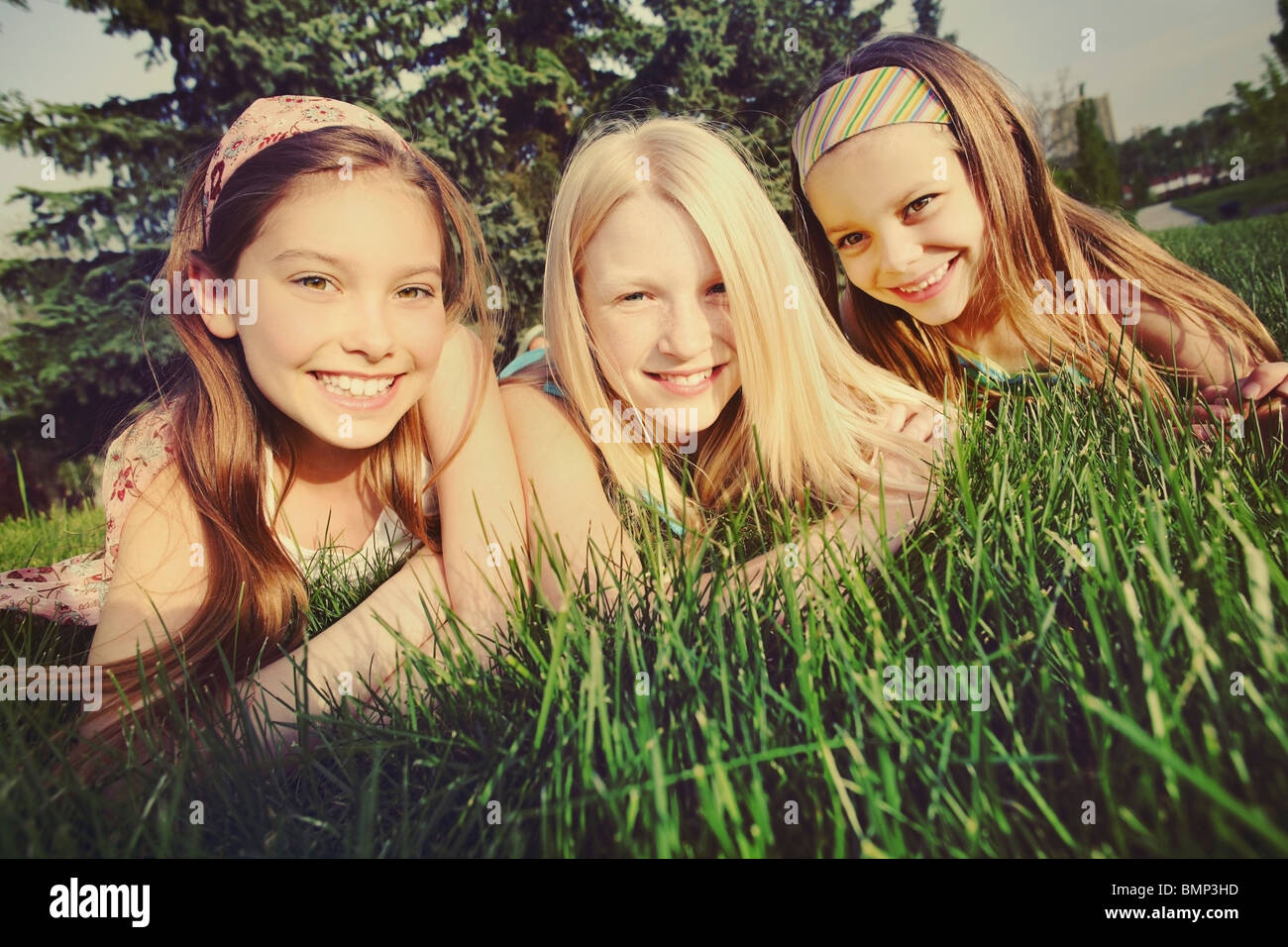 Edmonton, Alberta, Canada; Three Girls Laying On The Grass Stock Photo ...
