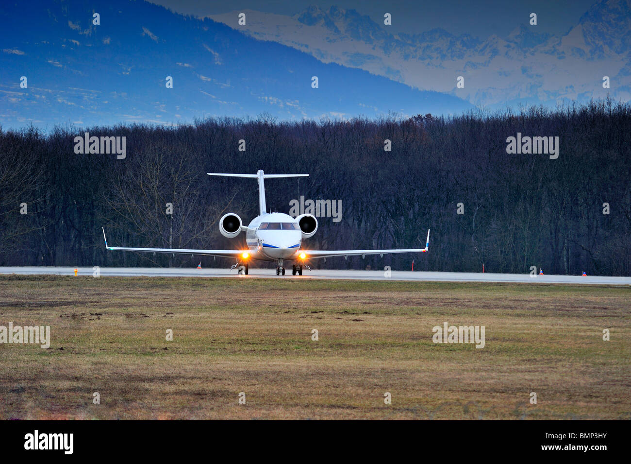 An aircraft lining up for takeoff on a winters evening at Geneva ...