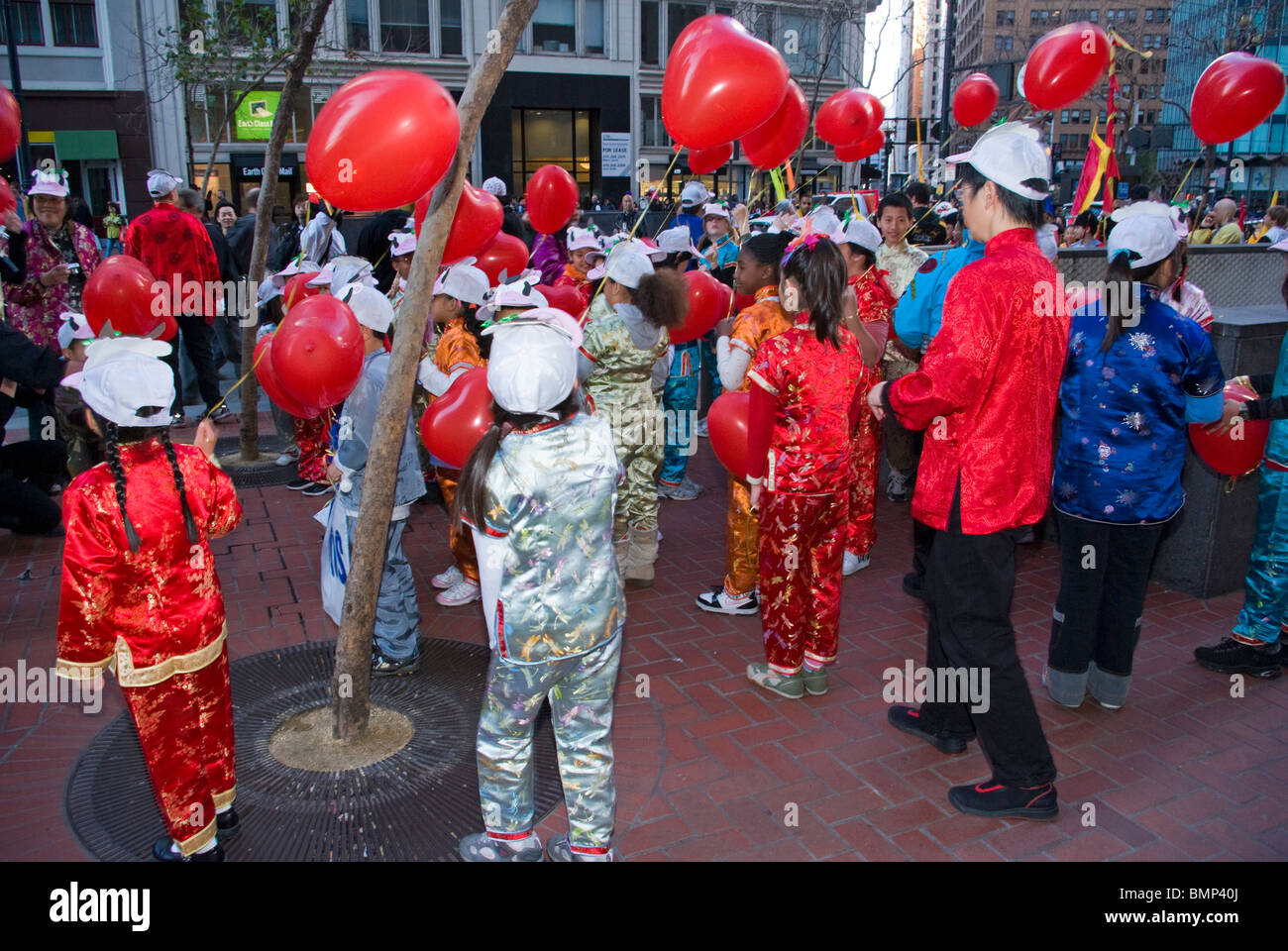 Chinese New Year parade, group of school children in bright regalia and ...