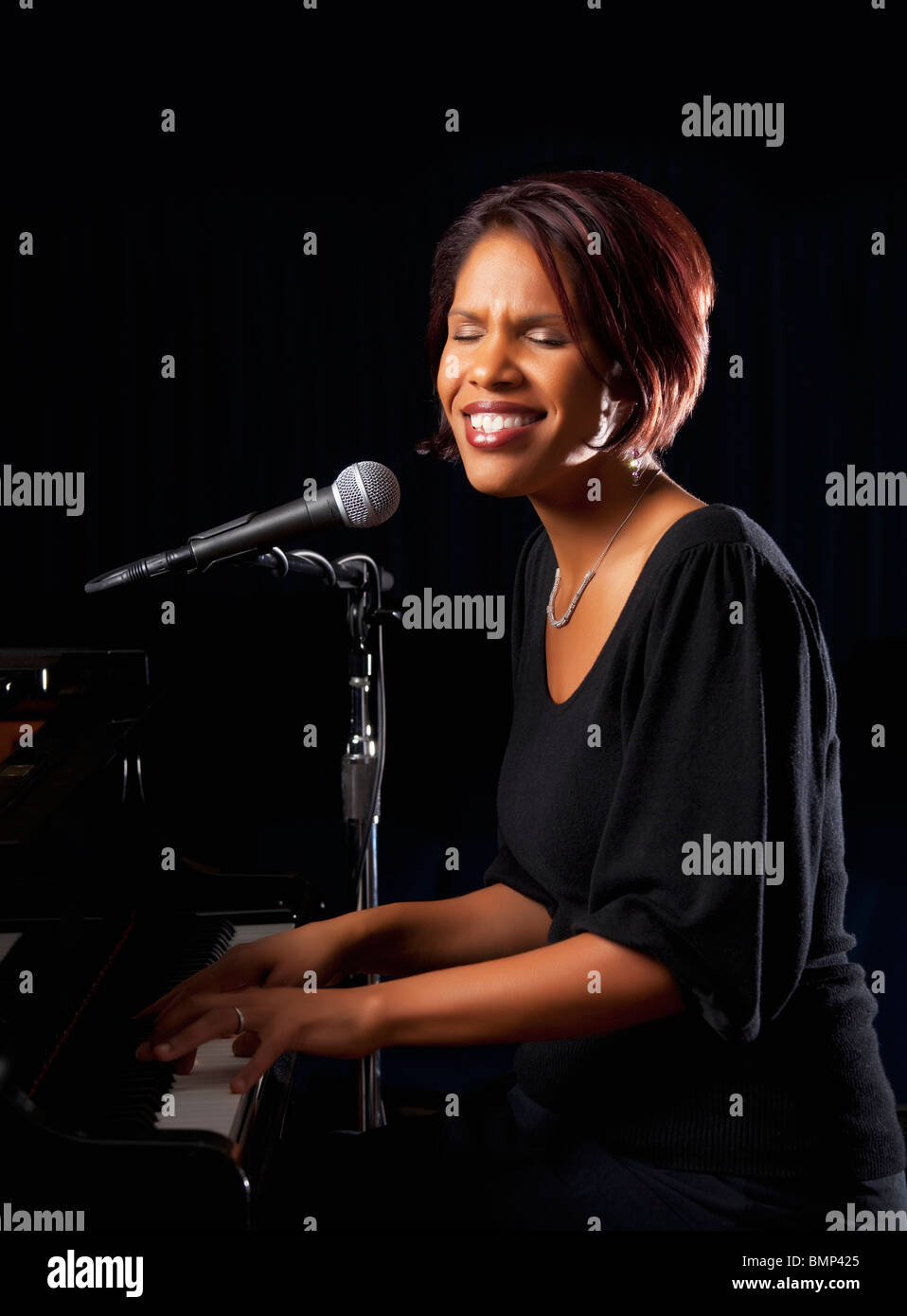 Woman singing playing piano hi-res stock photography and images - Alamy