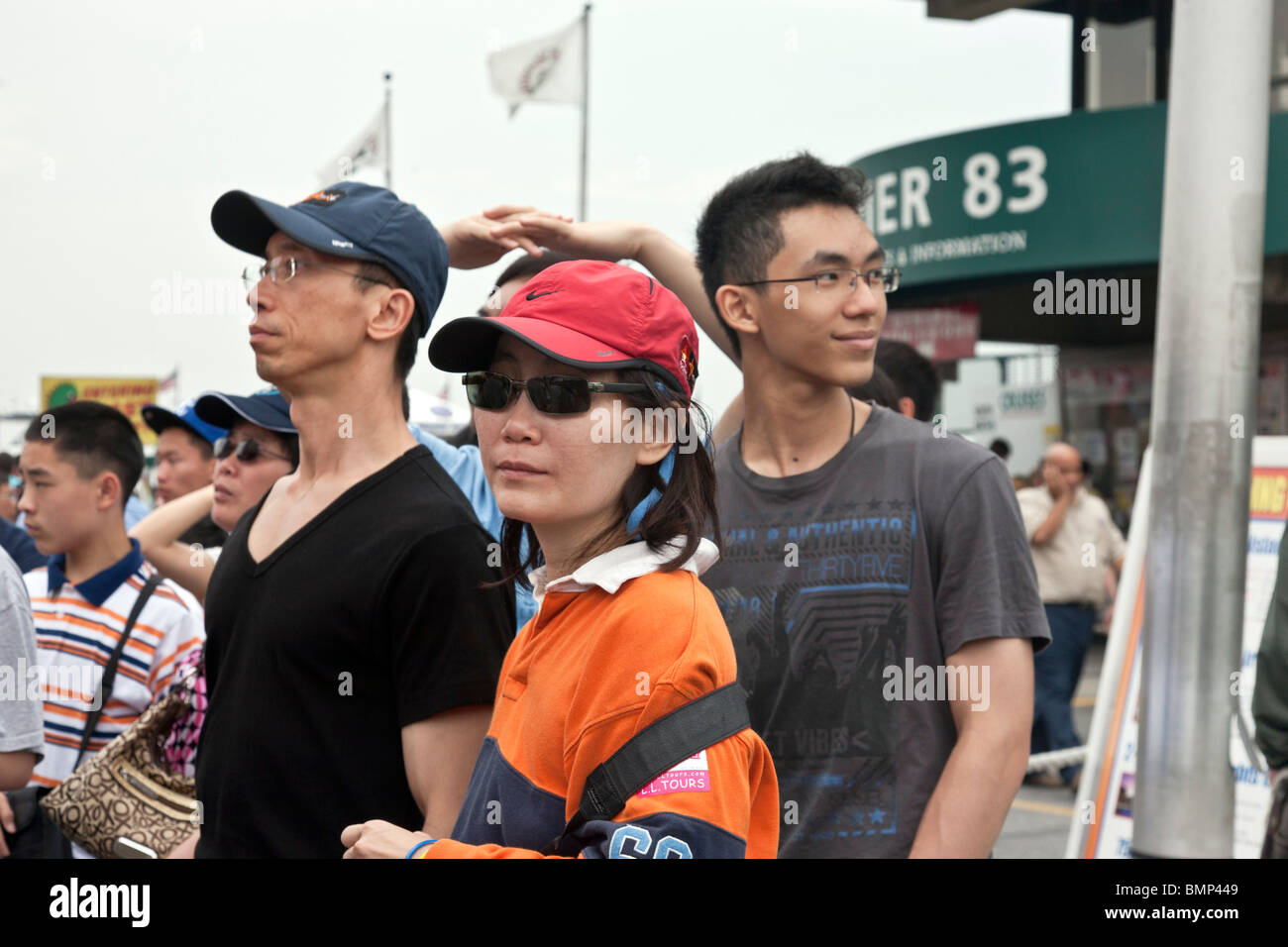 Japanese tourist couple with smiling teenage son in a guided tour group ...