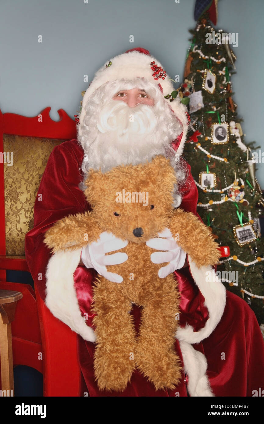 Edmonton, Alberta, Canada; Santa Claus Holding A Teddy Bear Stock Photo ...