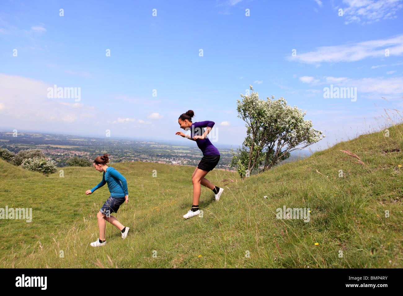 united kingdom west sussex the south downs two teenagers running down a ...
