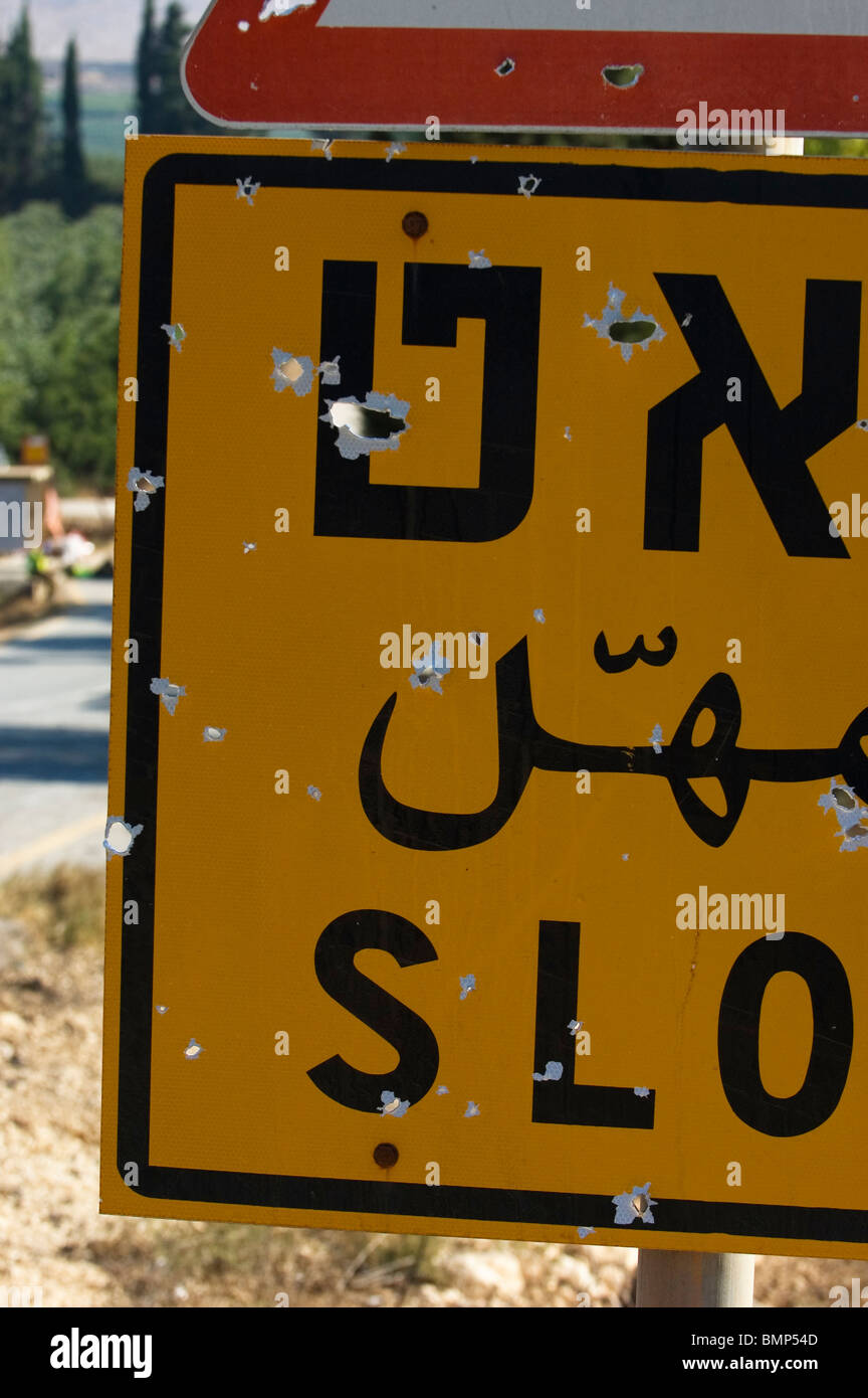Israeli road sign peppered with shrapnel damage from an Palestinian ...