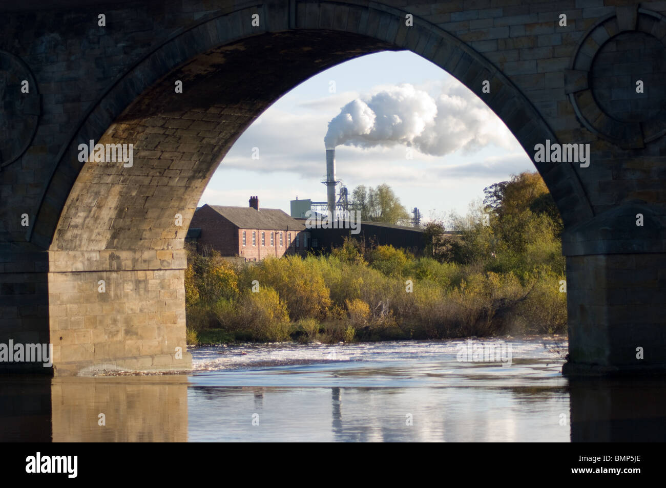 View of Egger's chipboard factory at Hexham through the arch of a stone ...
